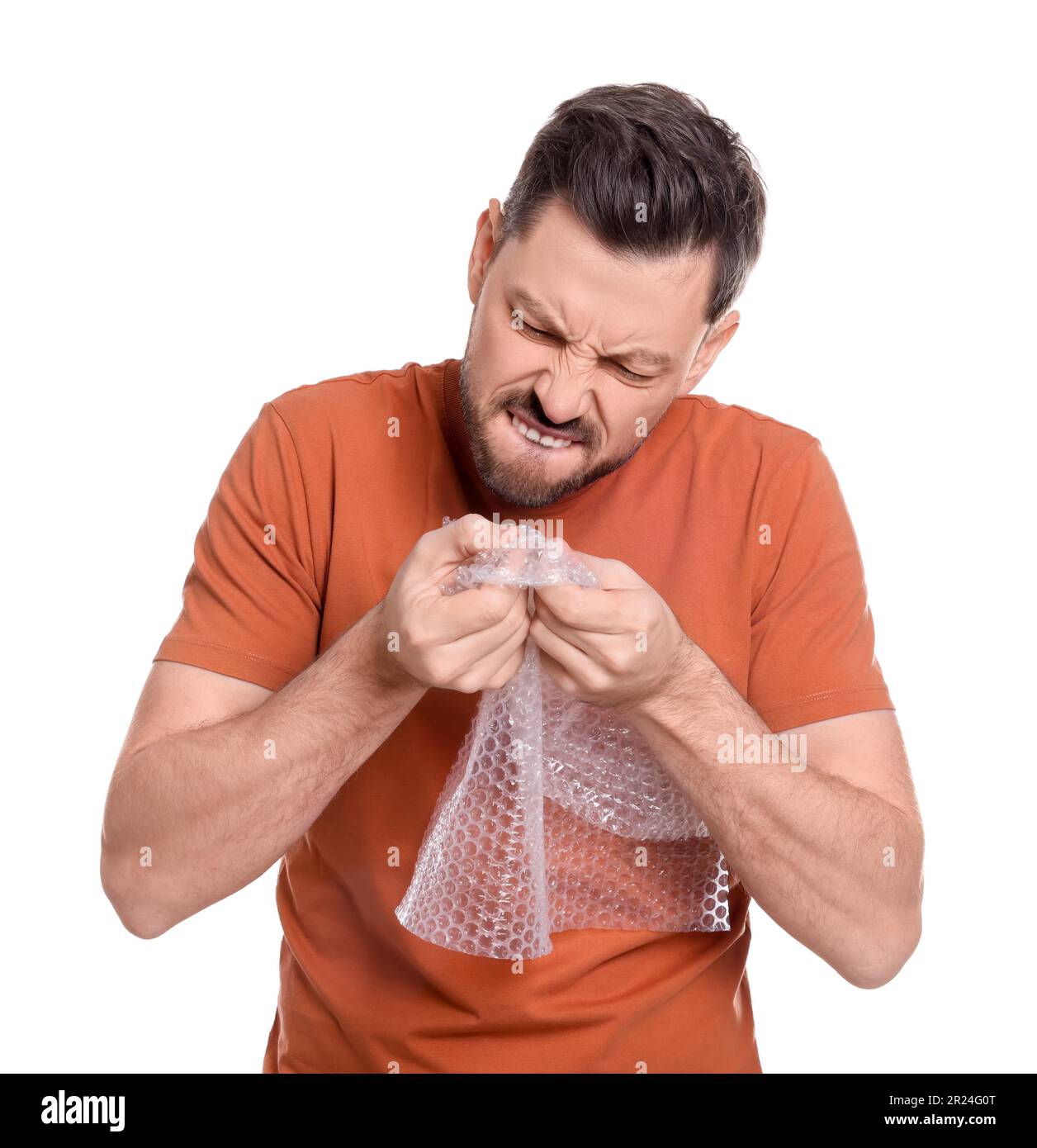 Man popping bubble wrap on white background. Stress relief Stock Photo ...