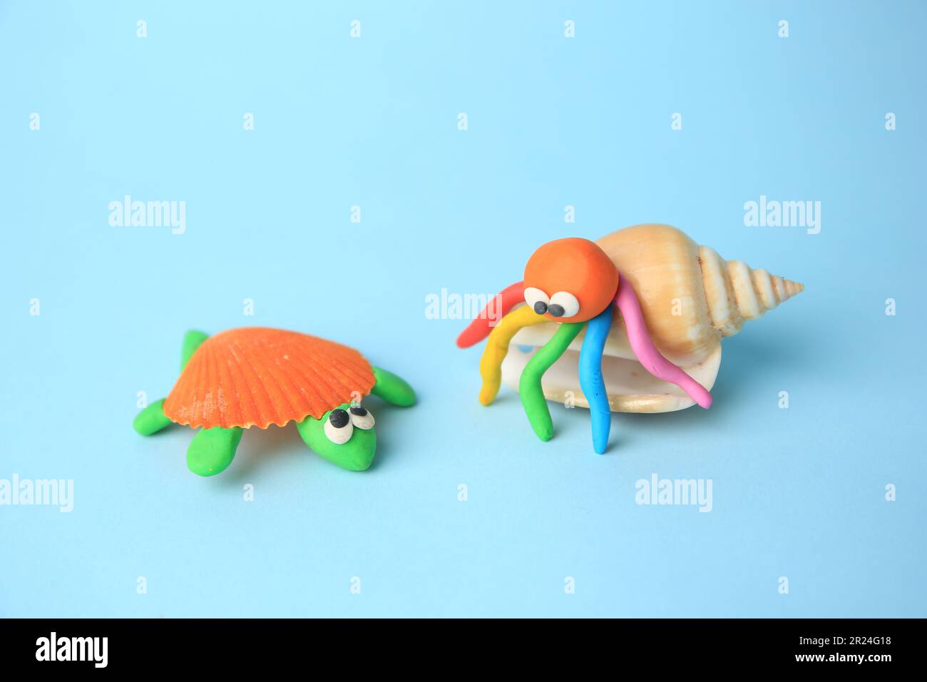 Turtle and crab made from plasticine on light blue background. Children ...