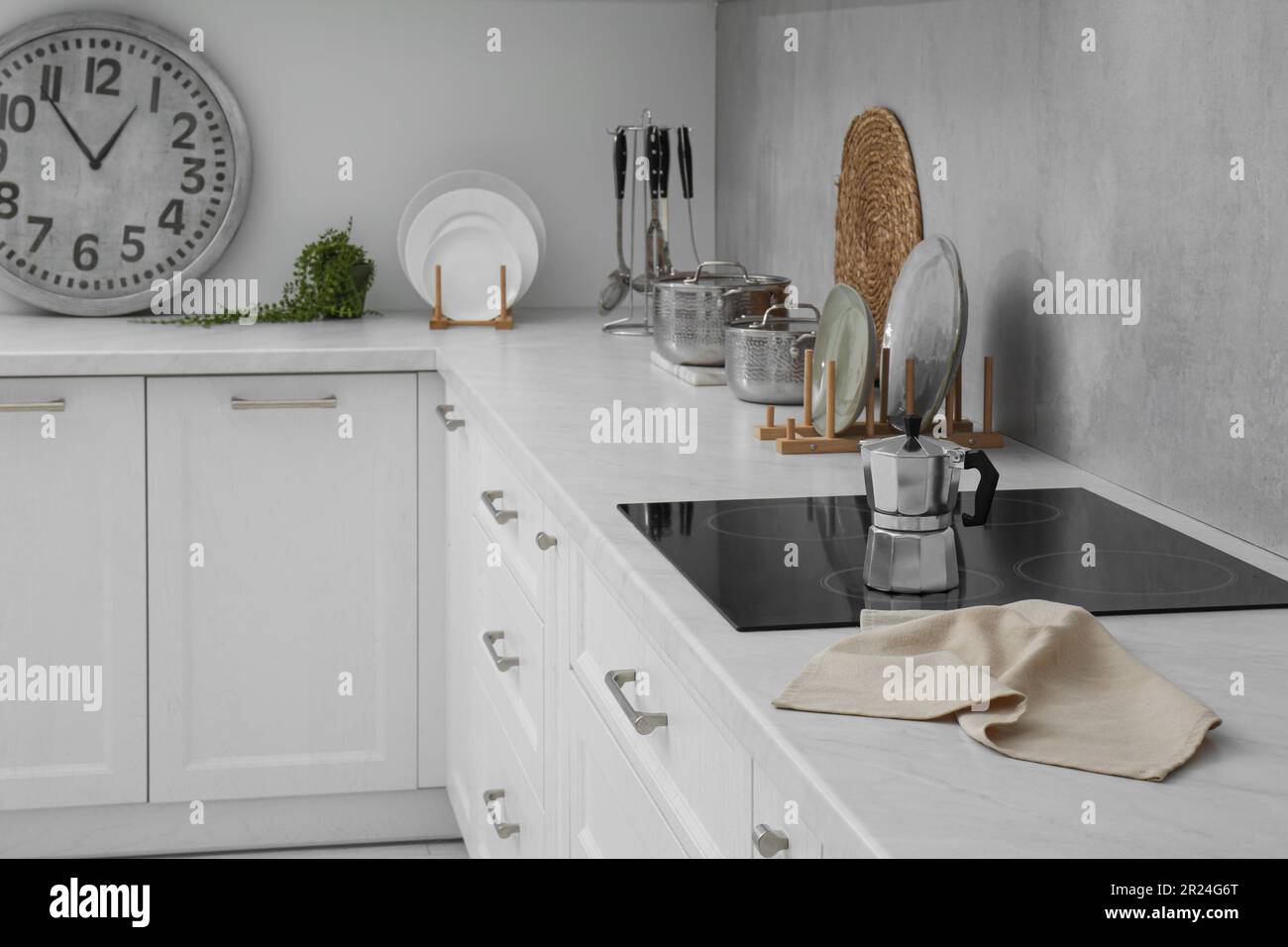 Moka pot on cooktop in kitchen. Beautiful interior Stock Photo - Alamy