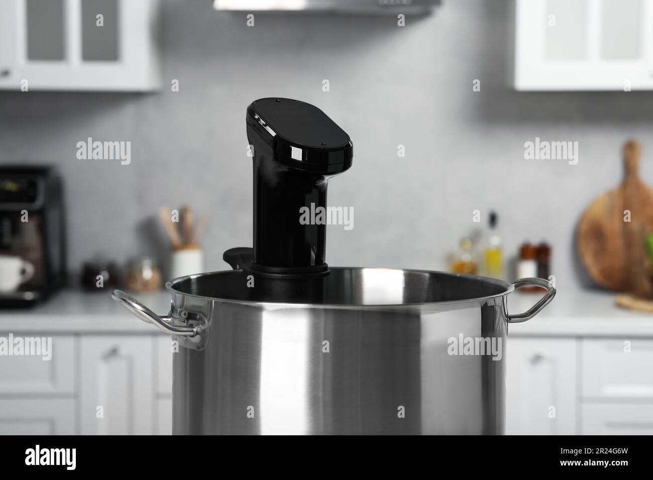 Pot with sous vide cooker in kitchen, closeup. Thermal immersion ...