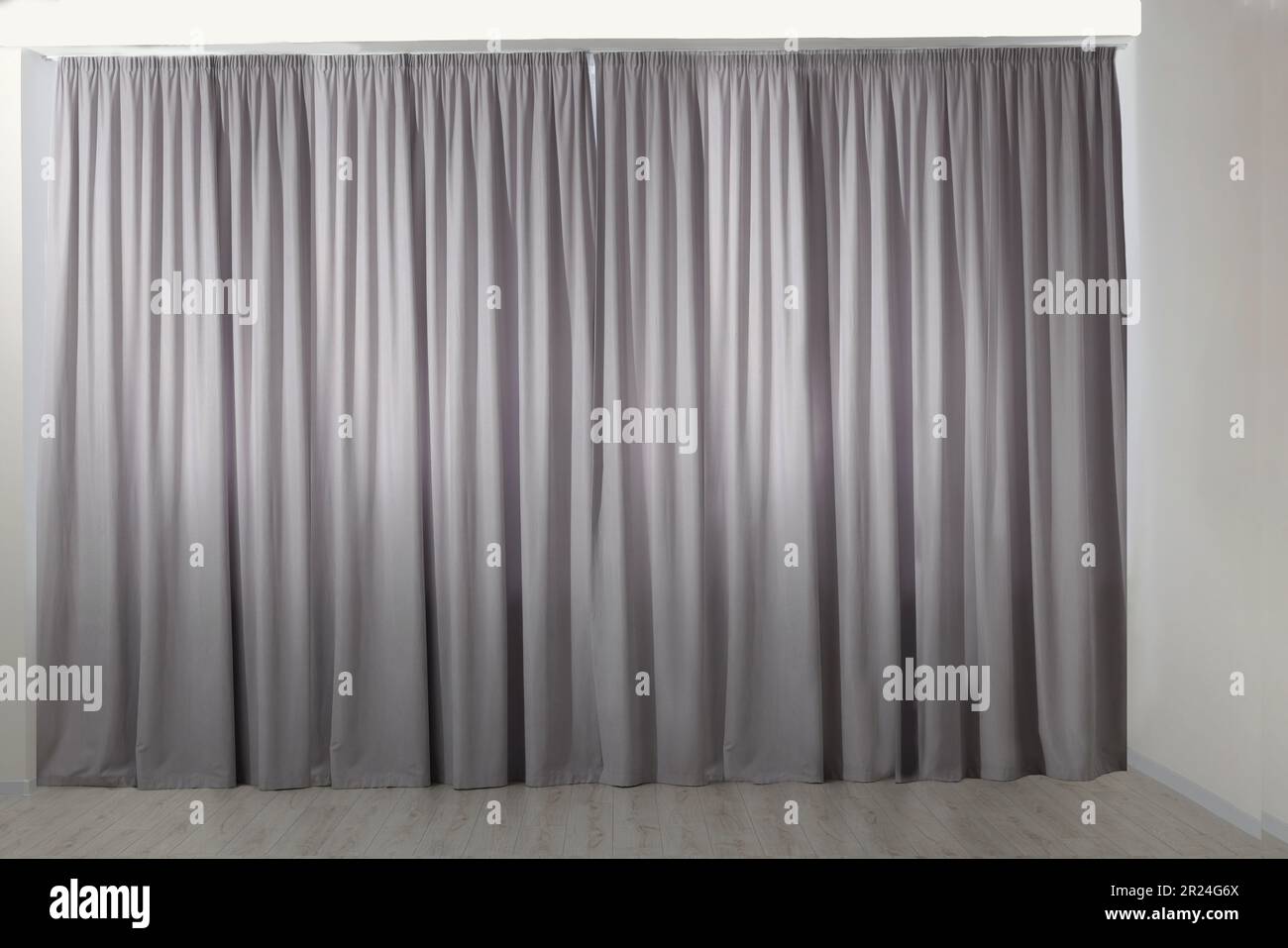 Light grey window curtains in living room Stock Photo - Alamy