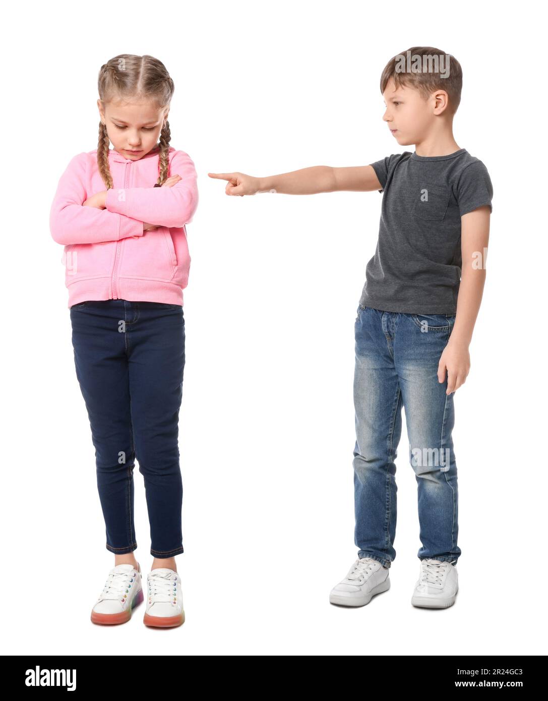 Boy pointing at upset girl on white background. Children's bullying ...