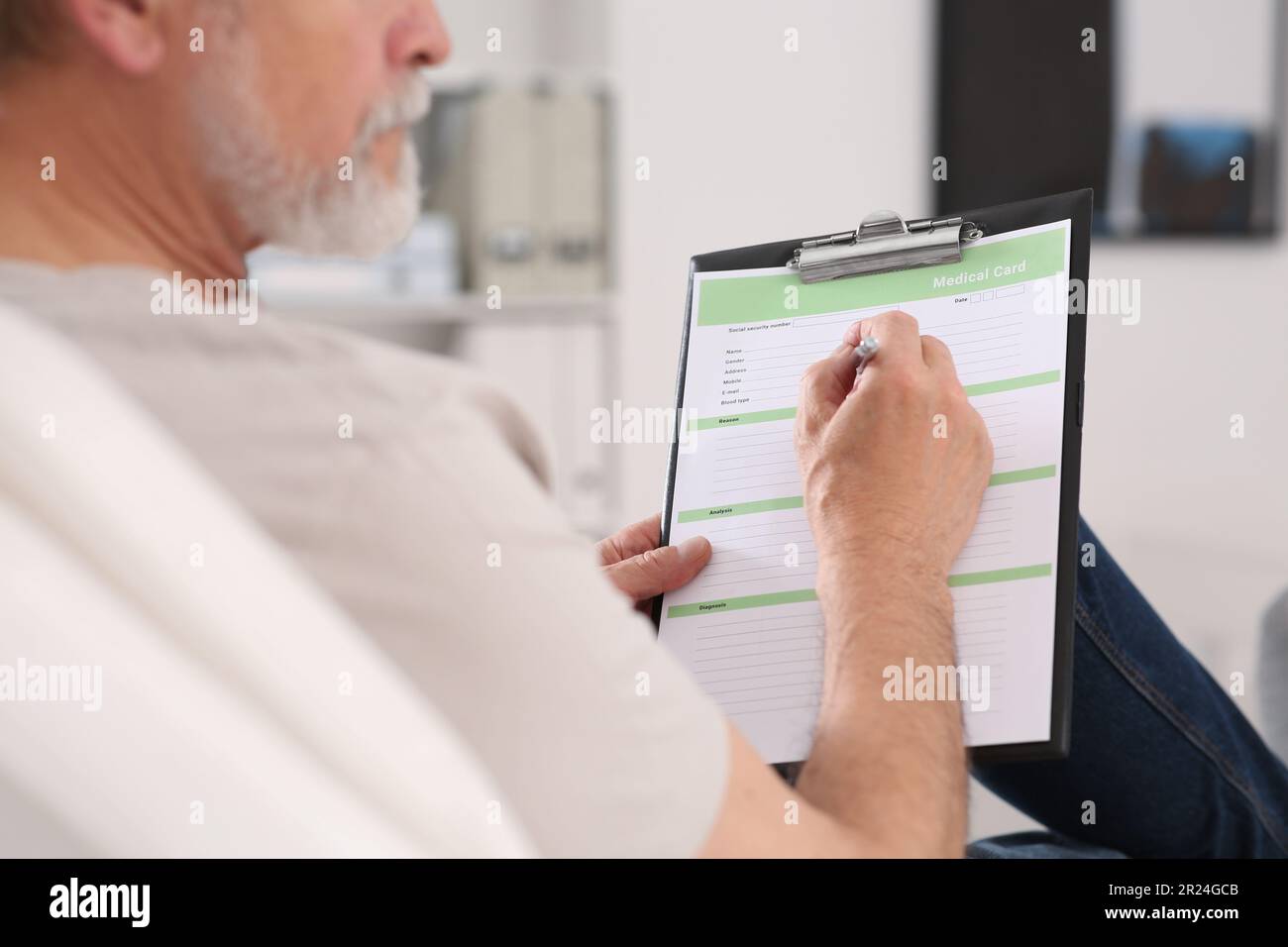 Patient filling his medical card in clinic, closeup Stock Photo - Alamy
