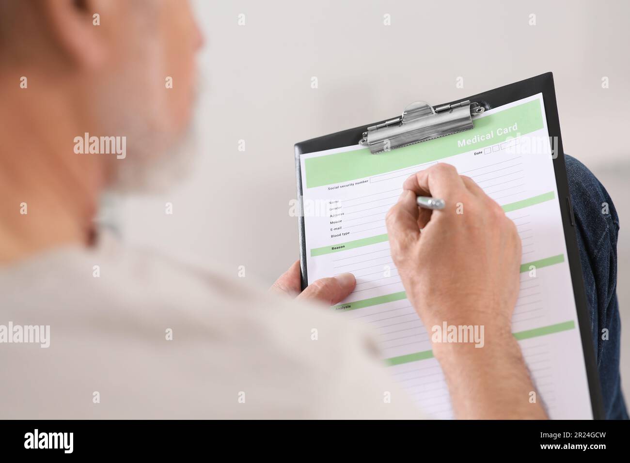 Patient filling his medical card in clinic, closeup Stock Photo - Alamy