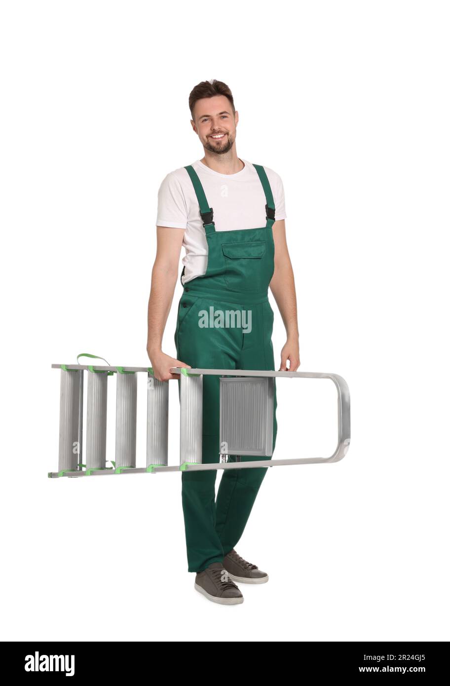 Worker in uniform holding metal ladder on white background Stock Photo ...