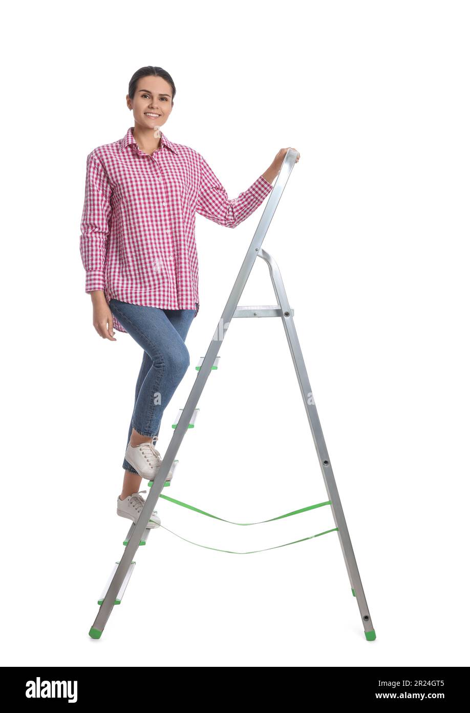 Young woman climbing up metal ladder on white background Stock Photo ...