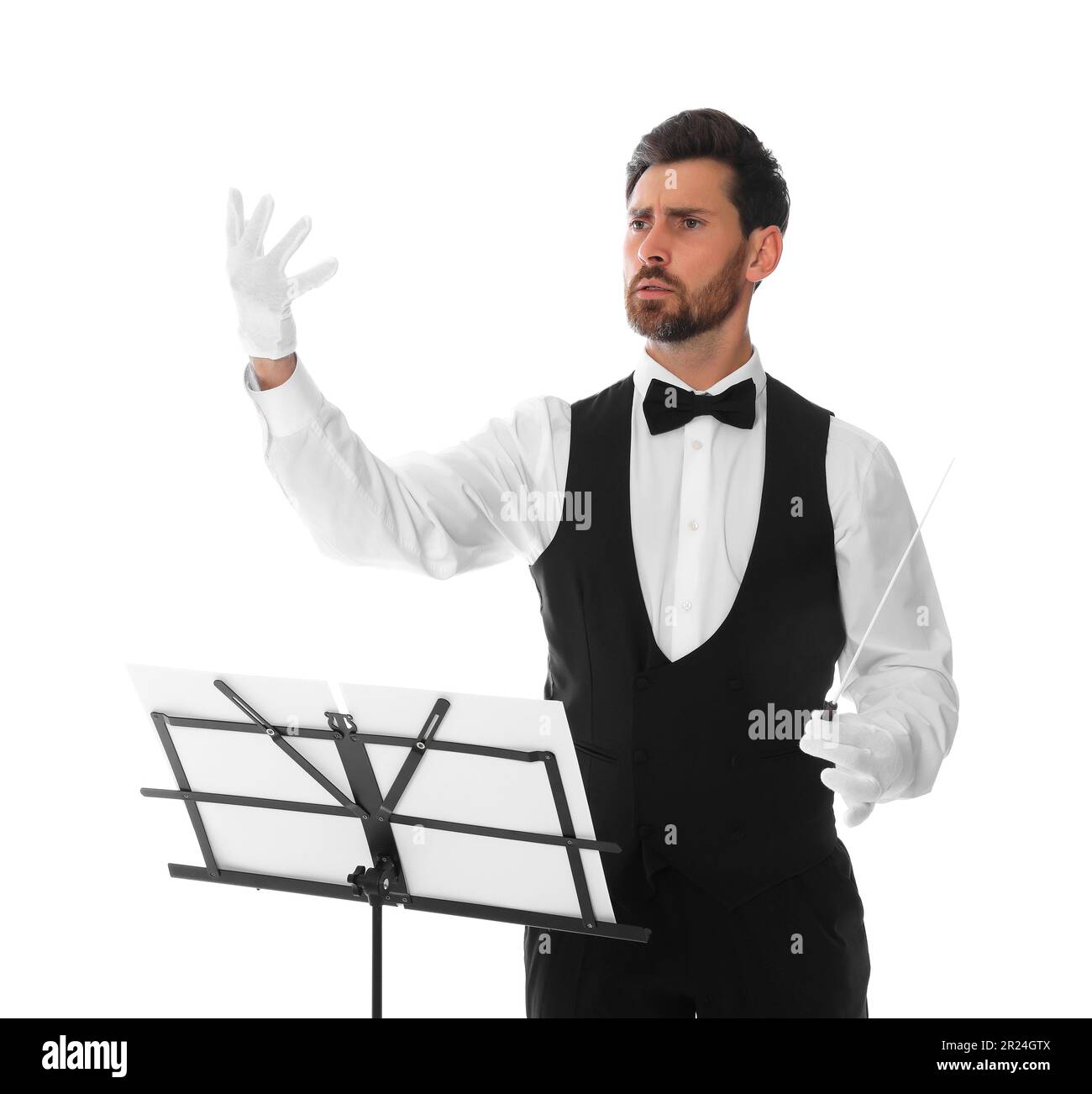 Professional conductor with baton and note stand on white background ...