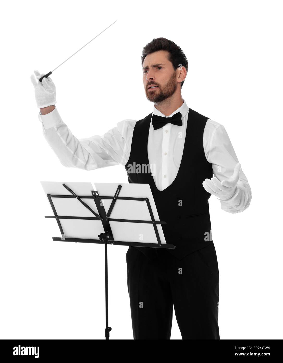 Professional conductor with baton and note stand on white background ...