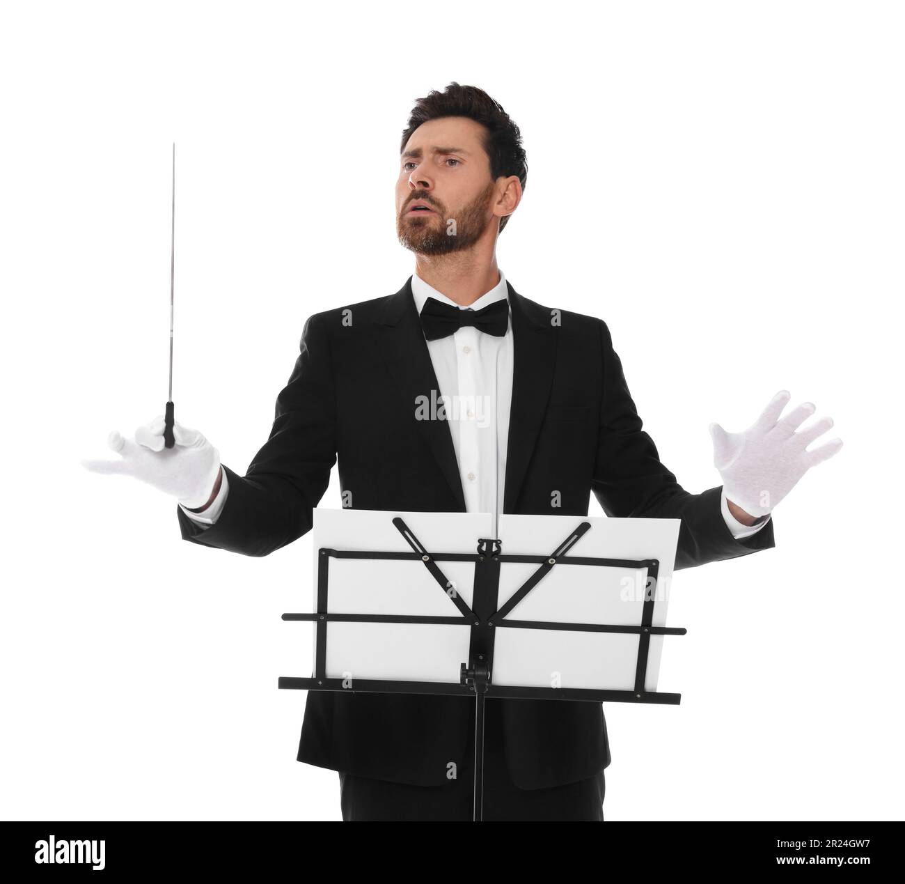 Professional conductor with baton and note stand on white background ...