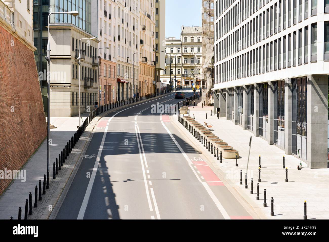 Beautiful road with car near buildings in city Stock Photo - Alamy