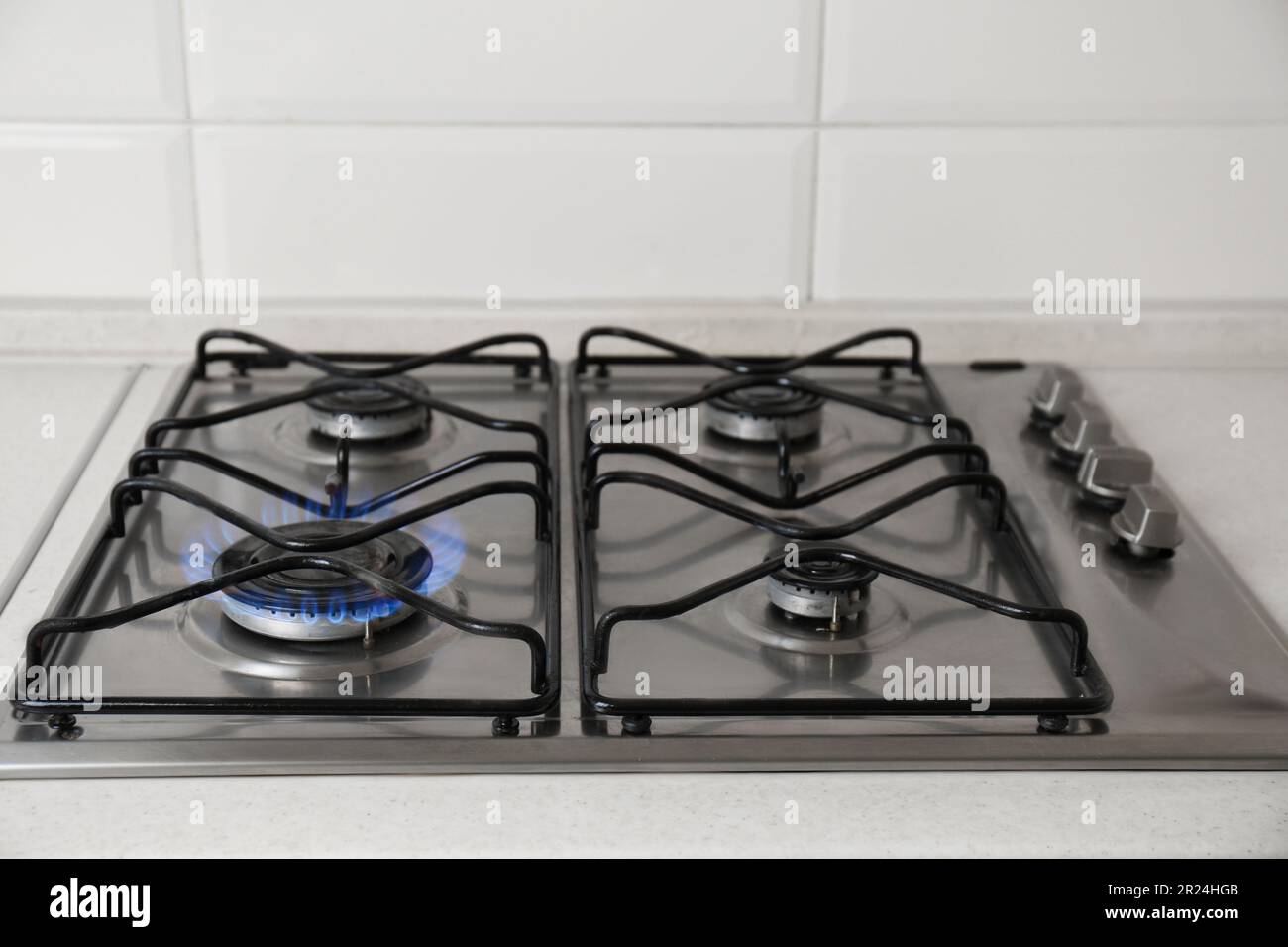 Gas cooktop with burning blue flame in kitchen Stock Photo - Alamy