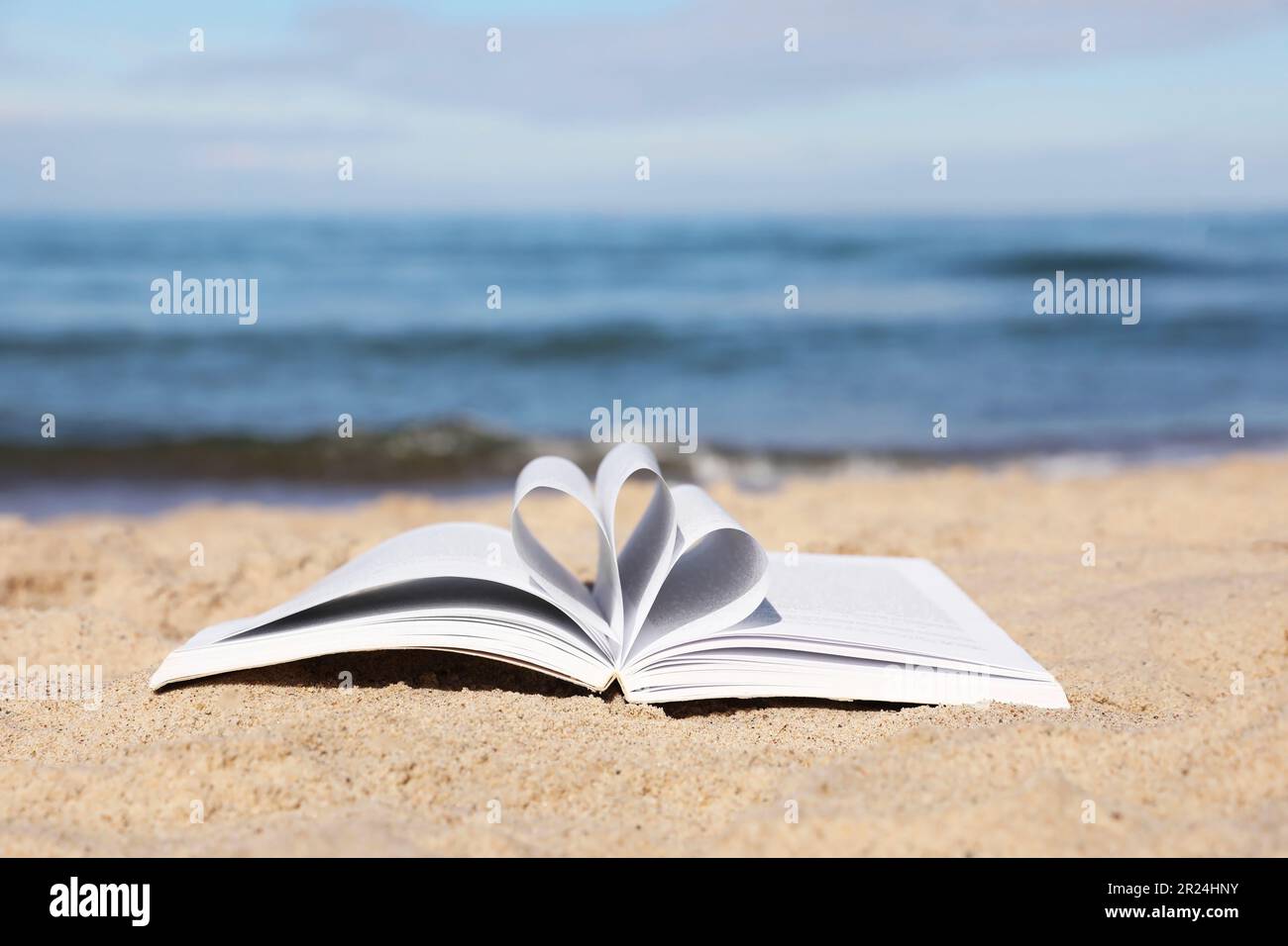 Open book on sandy beach near sea Stock Photo - Alamy
