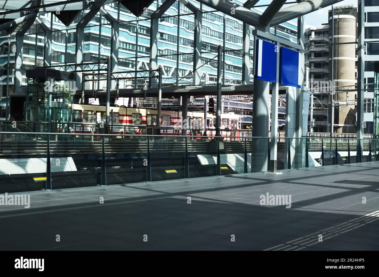 Modern railway station with platforms under overhang Stock Photo - Alamy