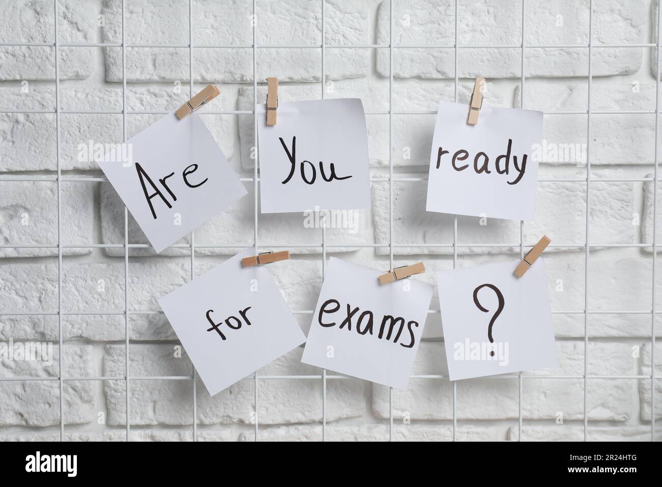 Notes with words Are you ready for exams hanging on white brick wall ...