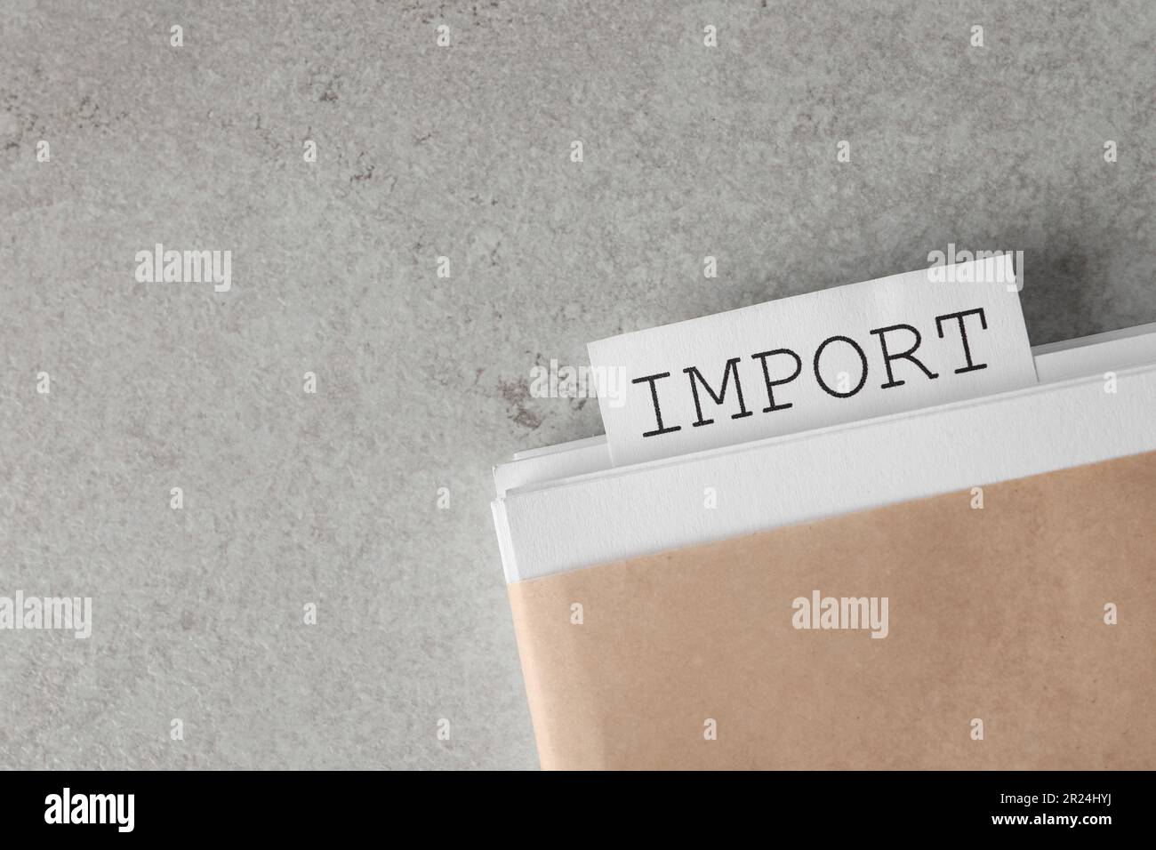 Note with word Import in documentation on light grey table, top view ...