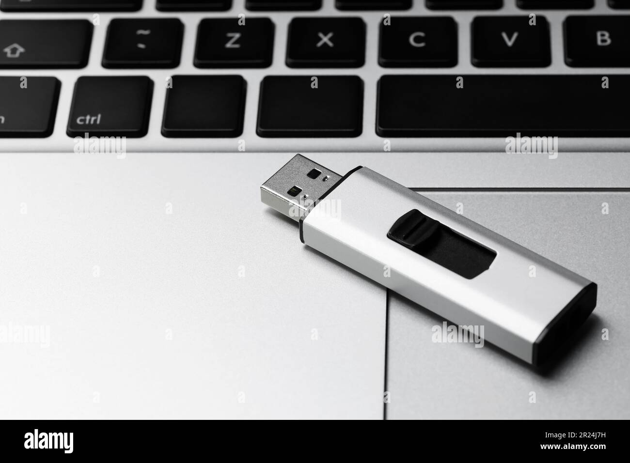 Modern usb flash drive on laptop, closeup. Space for text Stock Photo ...