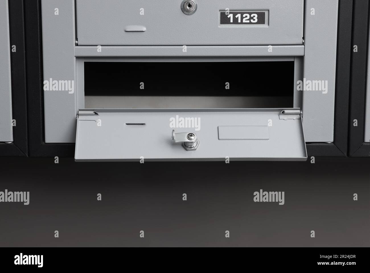 Open empty metal mailbox with keyhole indoors Stock Photo - Alamy
