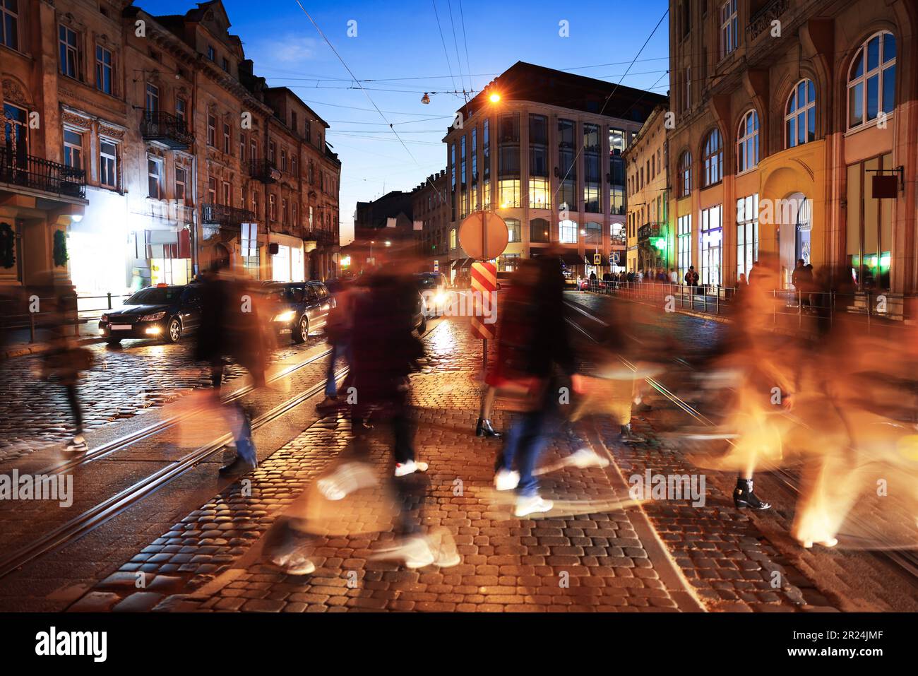 People crossing city street at night, long exposure effect Stock Photo - Alamy