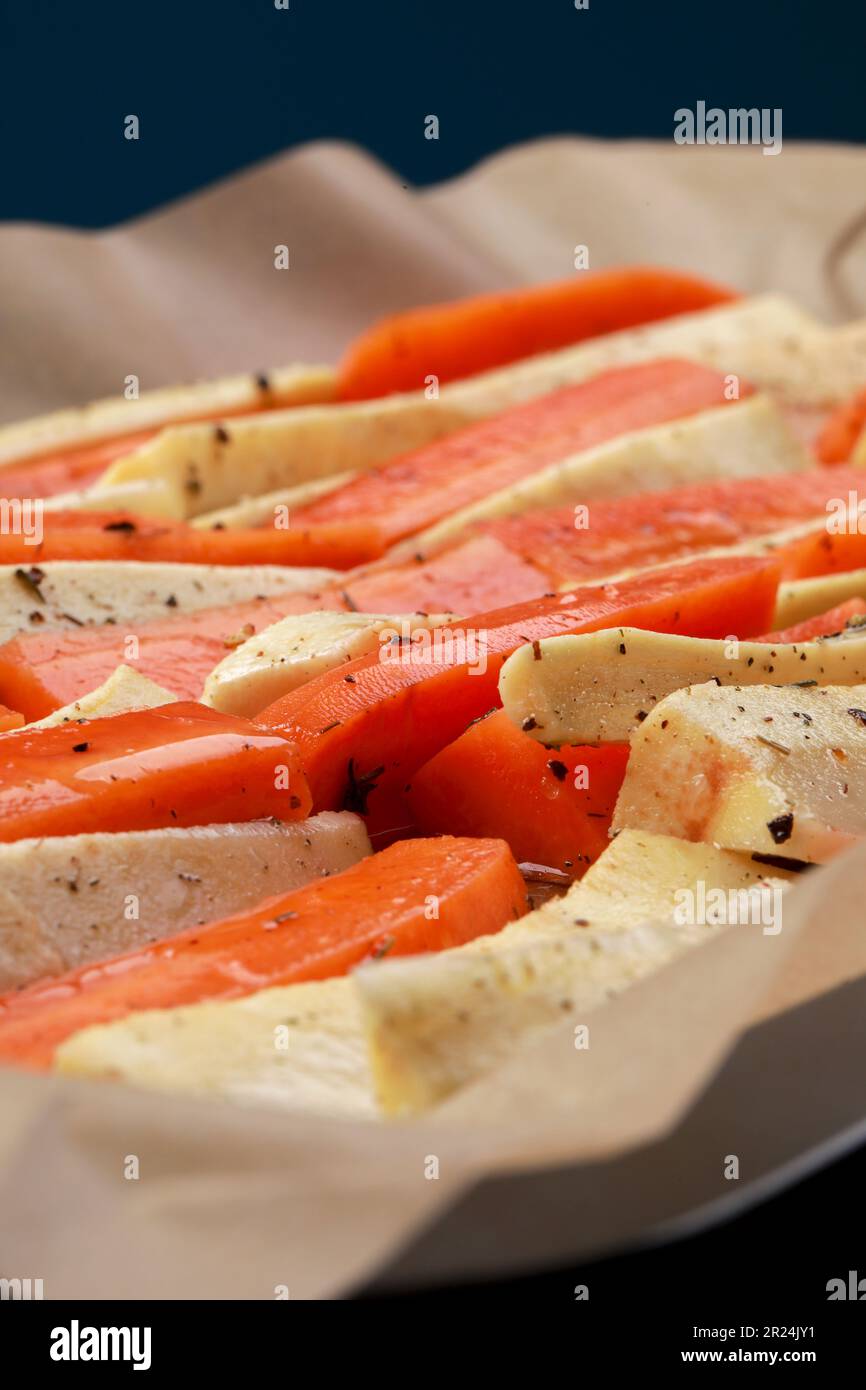 Slices of parsnip and carrot on baking tray, closeup Stock Photo - Alamy