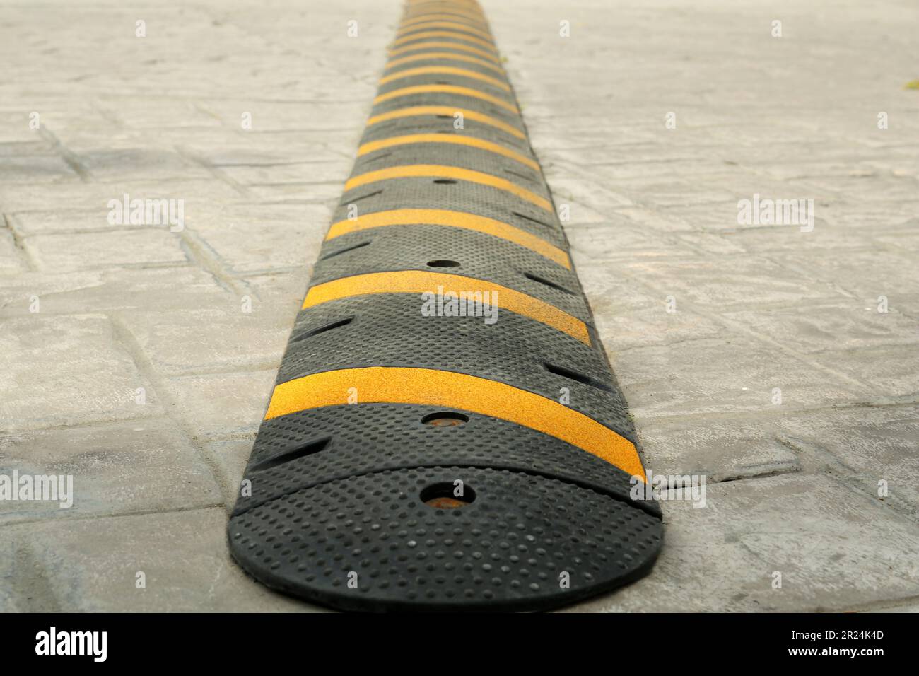 Striped plastic speed bump on pavement outdoors, closeup Stock Photo ...
