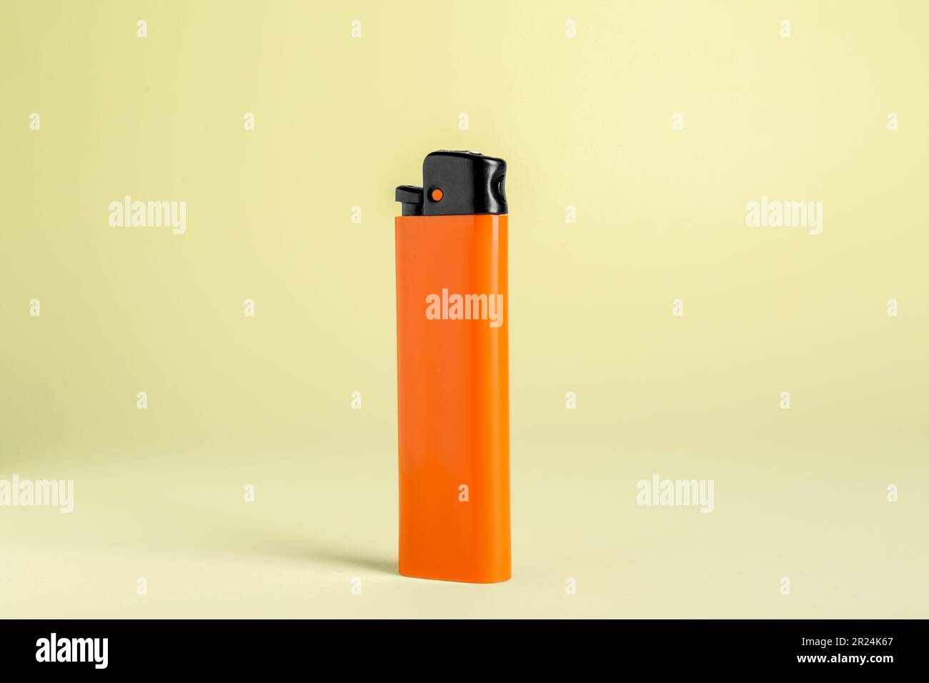 Stylish small pocket lighter on beige background Stock Photo - Alamy