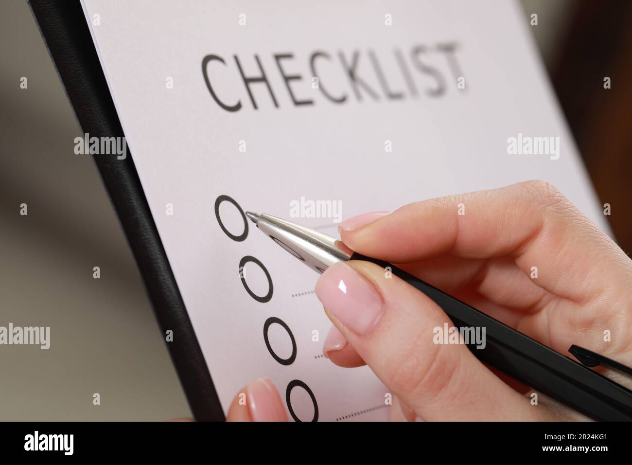 Woman filling Checklist with pen, closeup view Stock Photo - Alamy