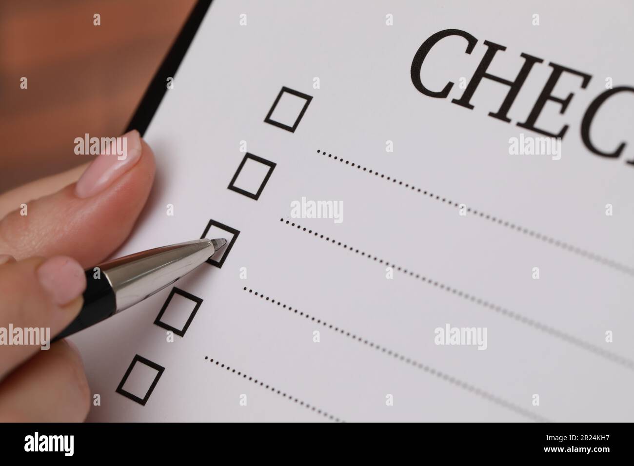 Woman filling Checklist with pen, closeup view Stock Photo - Alamy