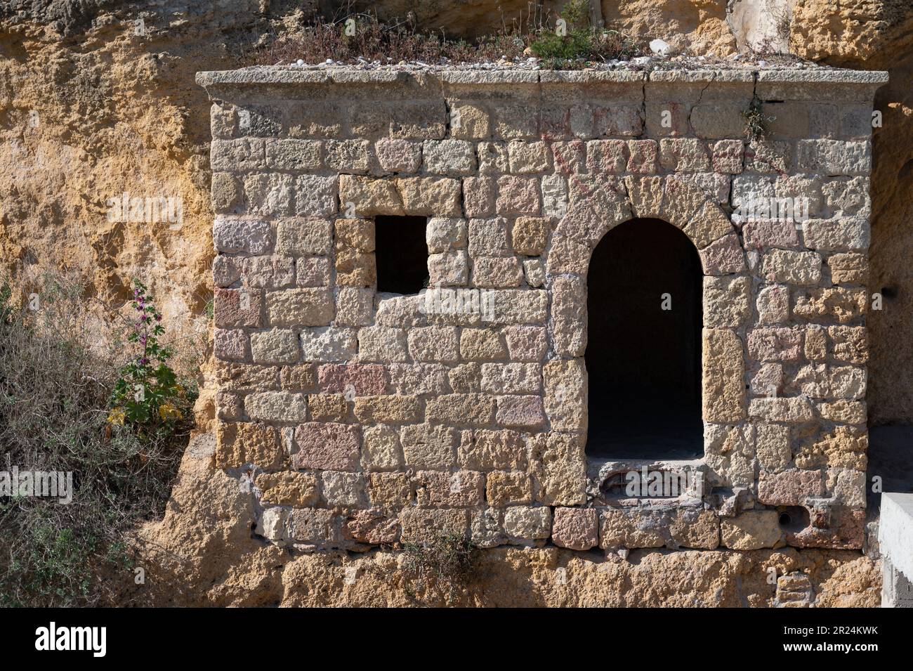 Detail of a small old stone house hidden on the beach Stock Photo - Alamy