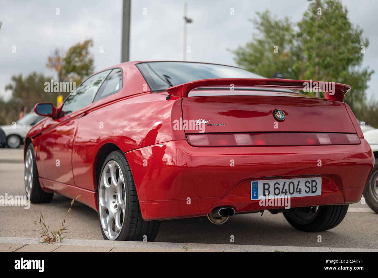 Rear view of the classic Italian sports car Alfa Romeo GTV in red color ...