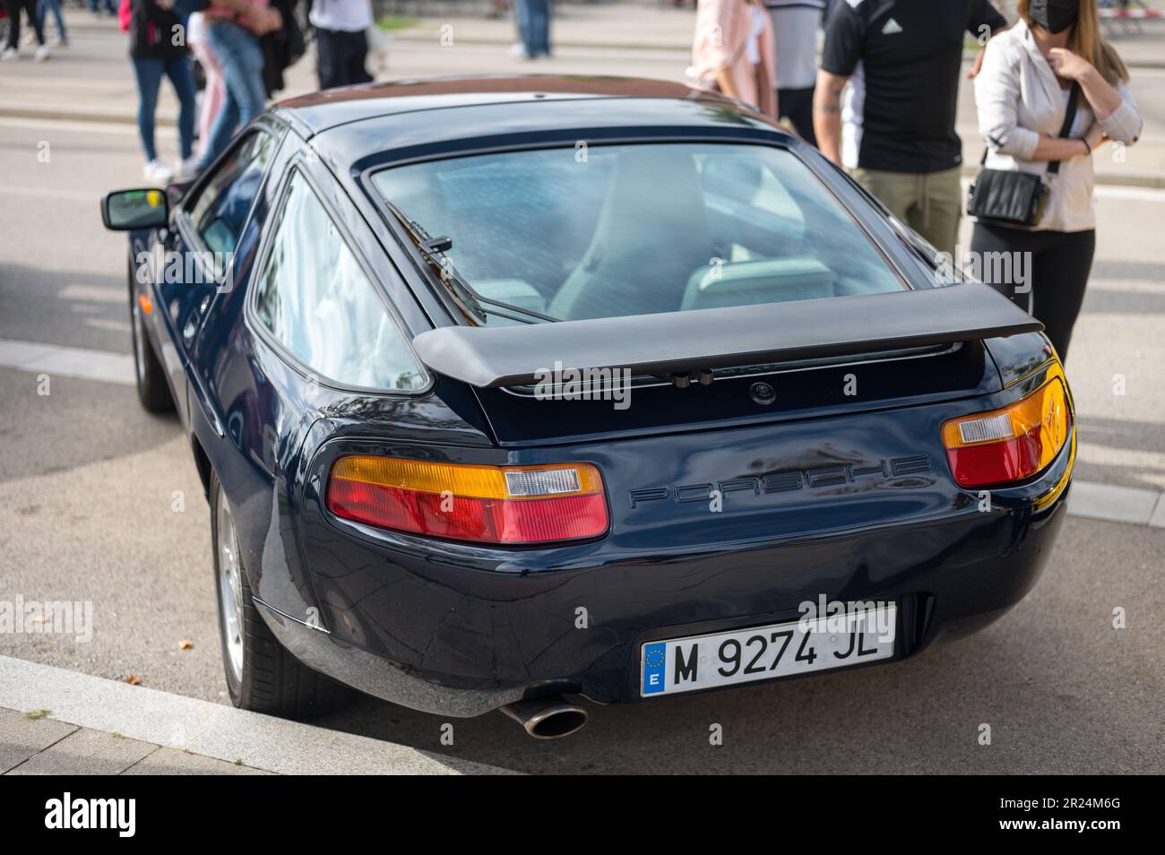 Rear view of an old classic black Porsche 928 parked in the street ...