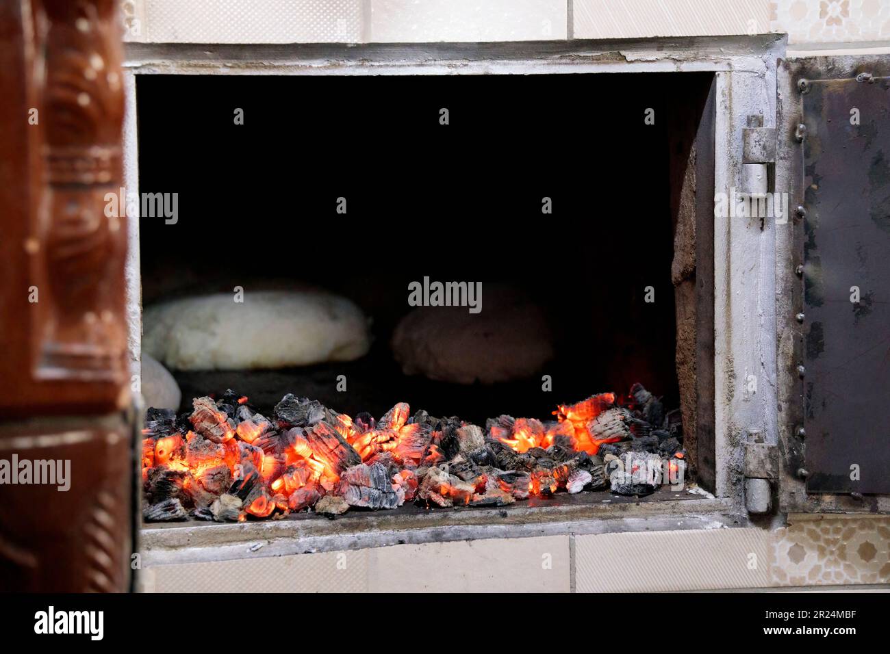 Home made bread roasting in to a traditional wood fire in a village ...