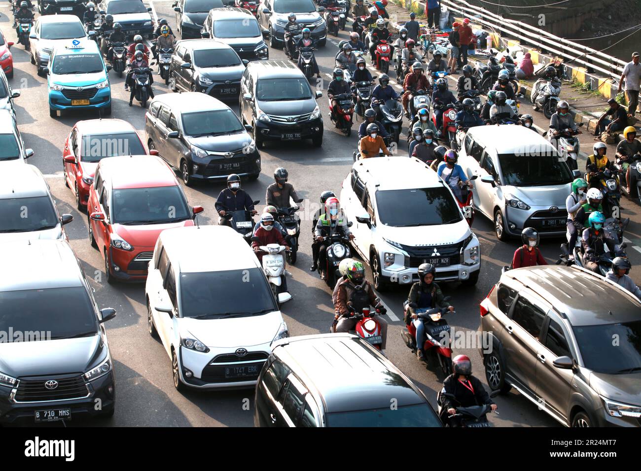 Jakarta, Indonesia-May 14, 2023: Busy traffic with chaotic vehicles scrambling on the highway ...