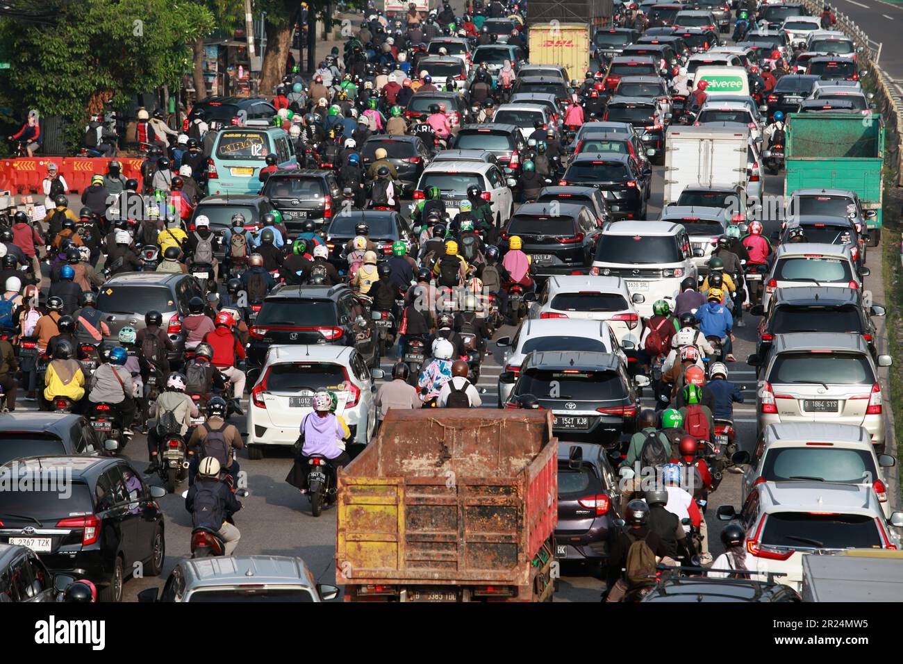 Jakarta, Indonesia-May 14, 2023: Busy traffic with chaotic vehicles scrambling on the highway ...