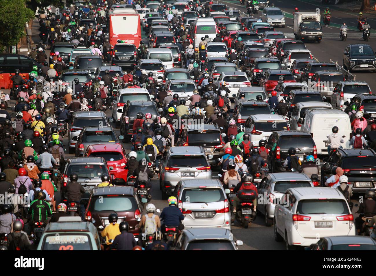 Jakarta, Indonesia-May 14, 2023: Busy traffic with chaotic vehicles scrambling on the highway ...