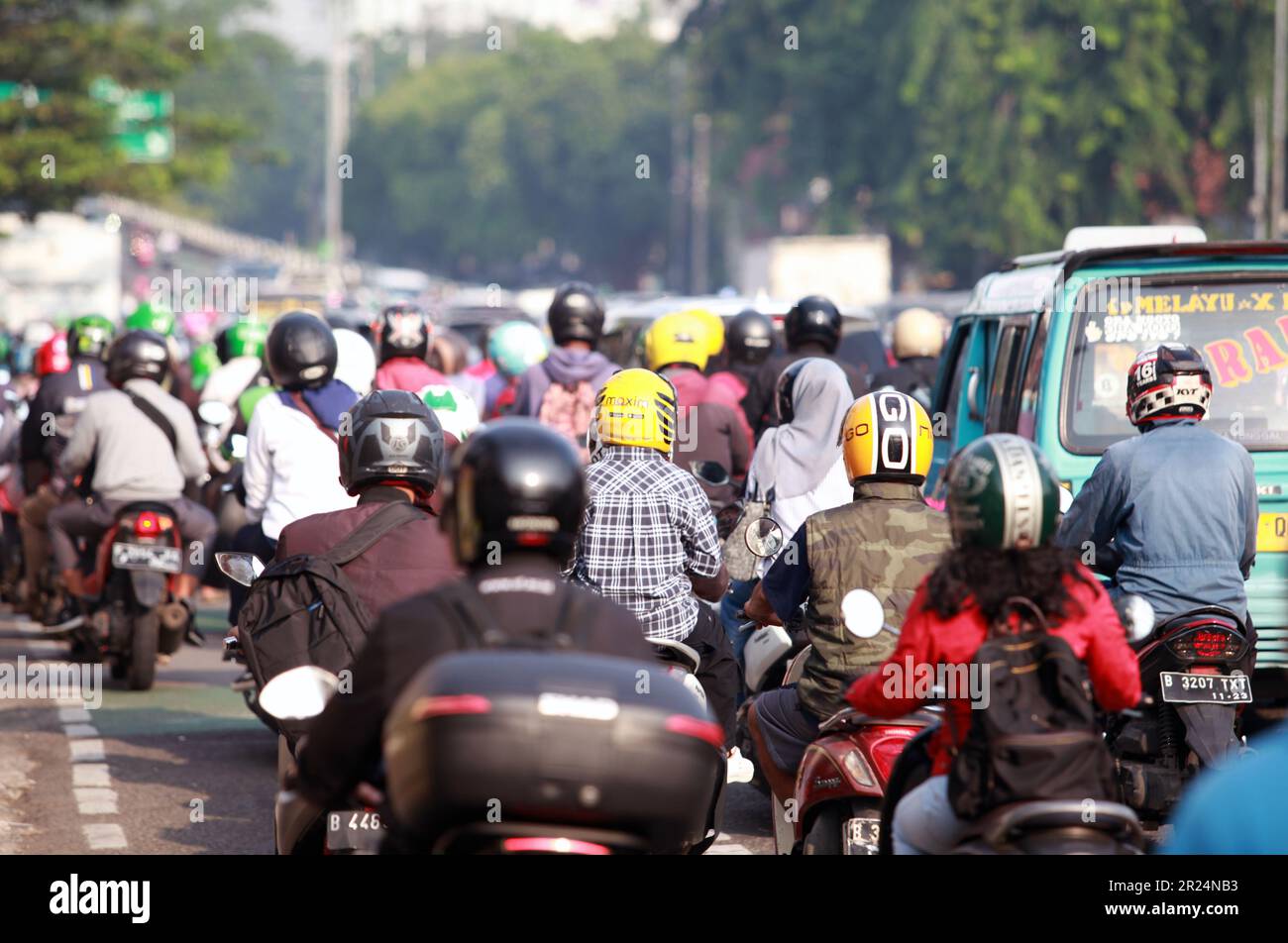 Jakarta, Indonesia-May 14, 2023: Busy traffic with chaotic vehicles scrambling on the highway ...