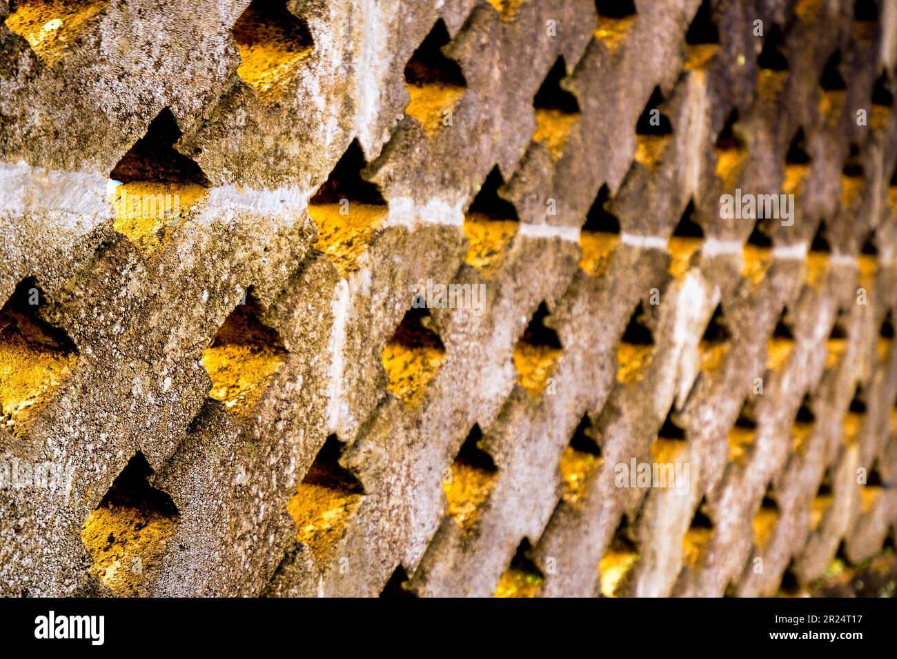 perforated concrete wall texture with selective focus for backgound ...