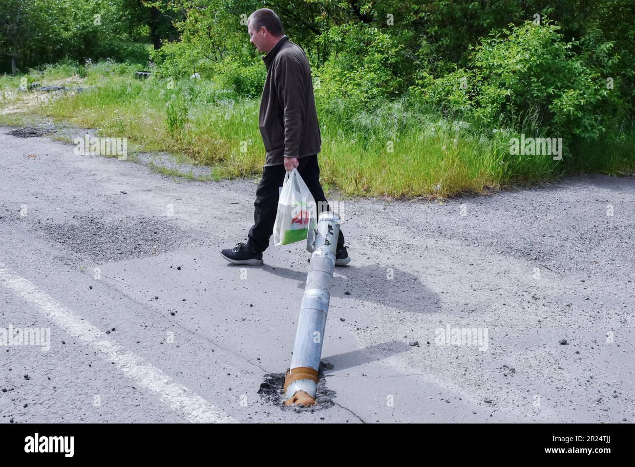 Orikhiv, Ukraine. 16th May, 2023. Alexander (45), seen walking past a ...