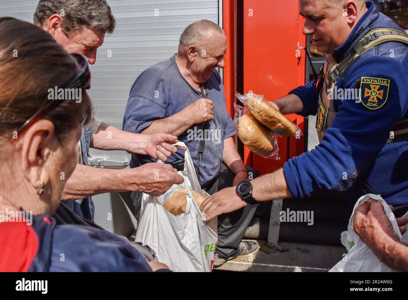 Orikhiv, Ukraine. 16th May, 2023. People receives bread at a ...