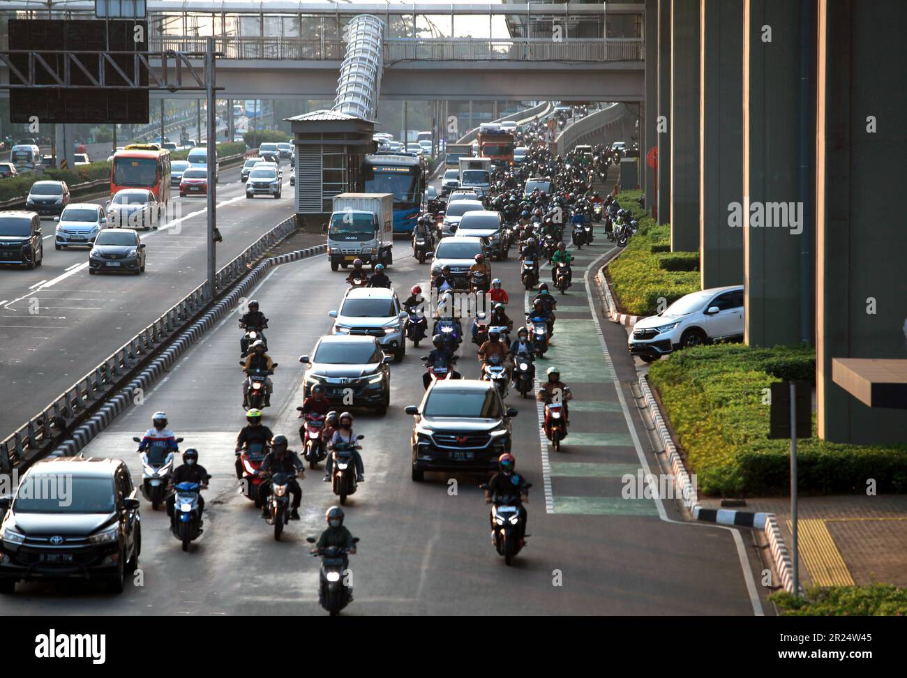 Jakarta, Indonesia-May 14, 2023: Busy traffic with chaotic vehicles scrambling on the highway ...
