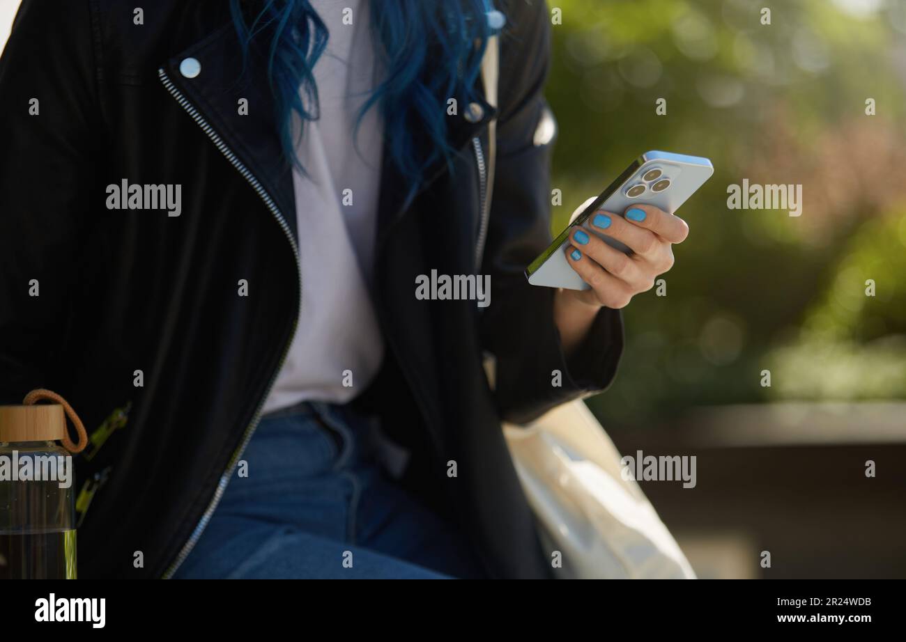 Female person using a mobile app on a smartphone. Unrecognizable young ...