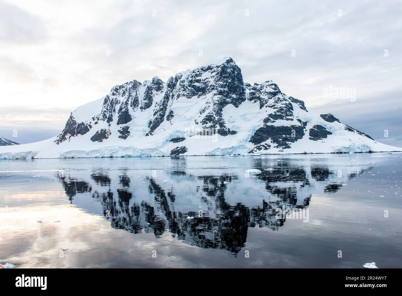 Lemaire Channel, Antarctica. Quiet reflection of a mountain on the ...