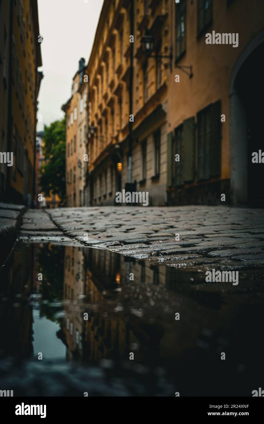 Puddle on alley street hi-res stock photography and images - Alamy