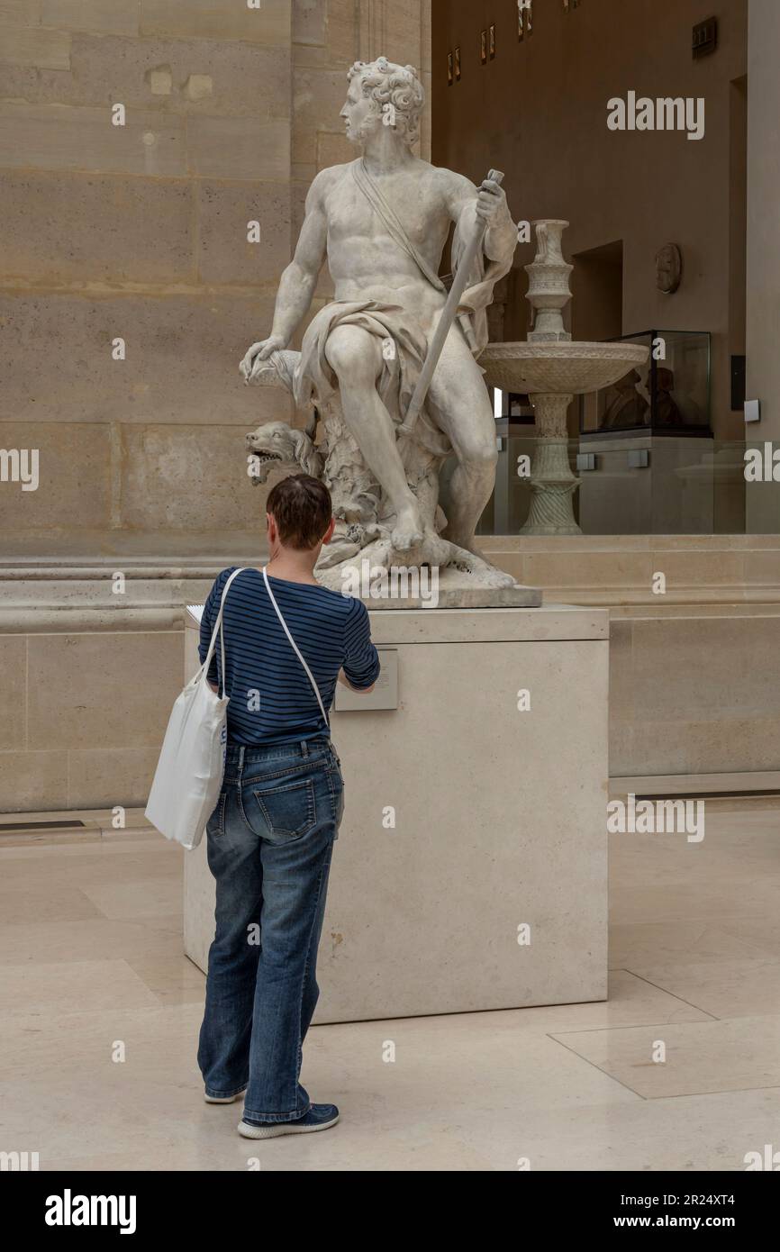 Paris, France - 05 13 2023: Louvre Museum. A woman draws the Sculpture ...