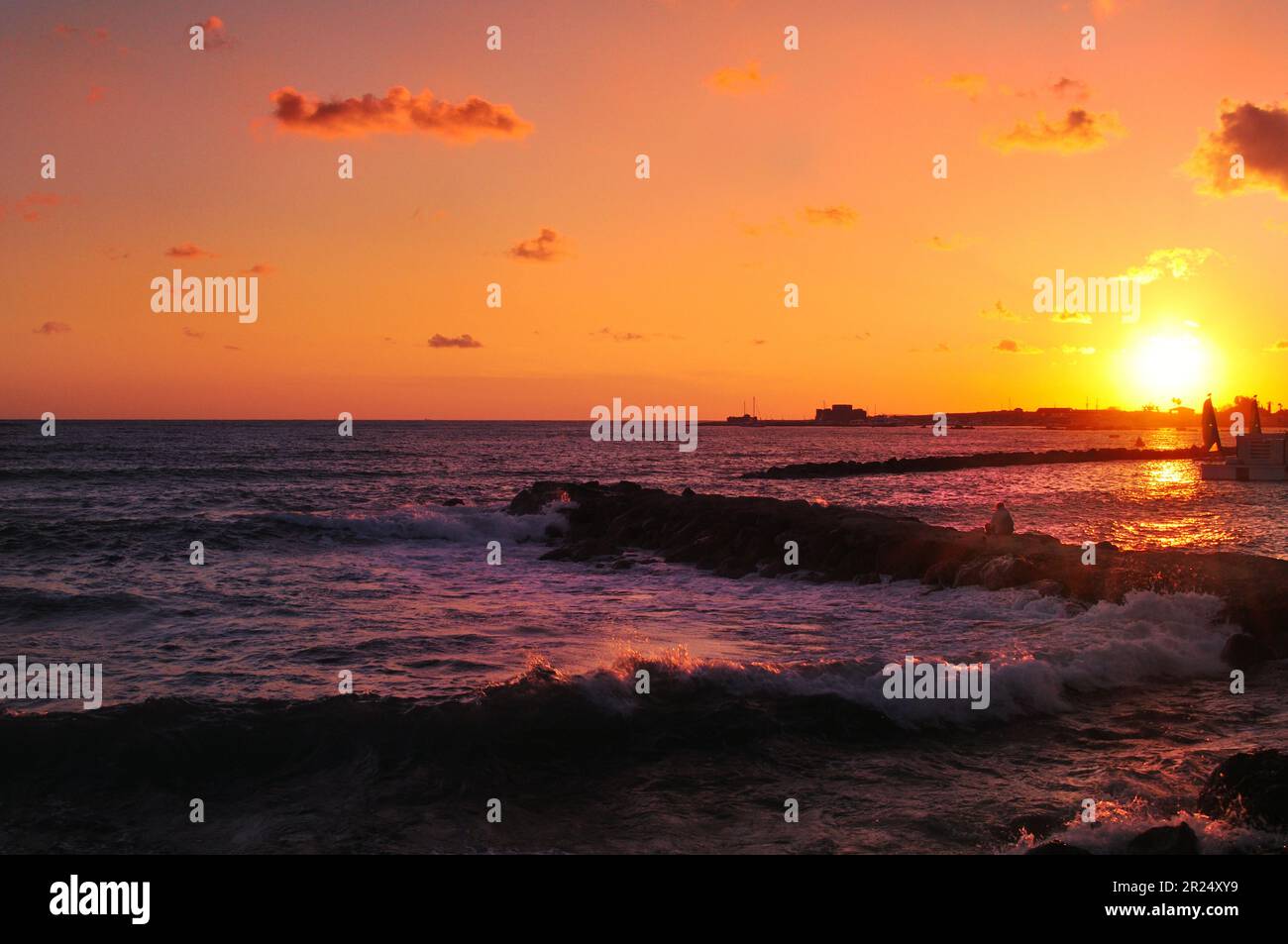 A person gazing at the sunset over the sea in the vicinity of the ...