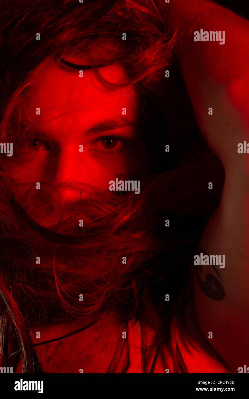 Close-up portrait of handsome young man with hair all over his face ...