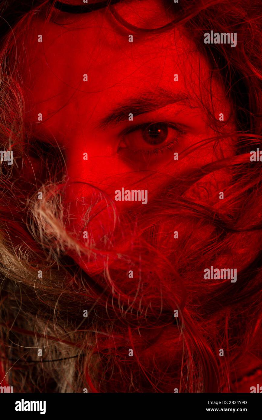 Close-up portrait of handsome young man with hair all over his face ...