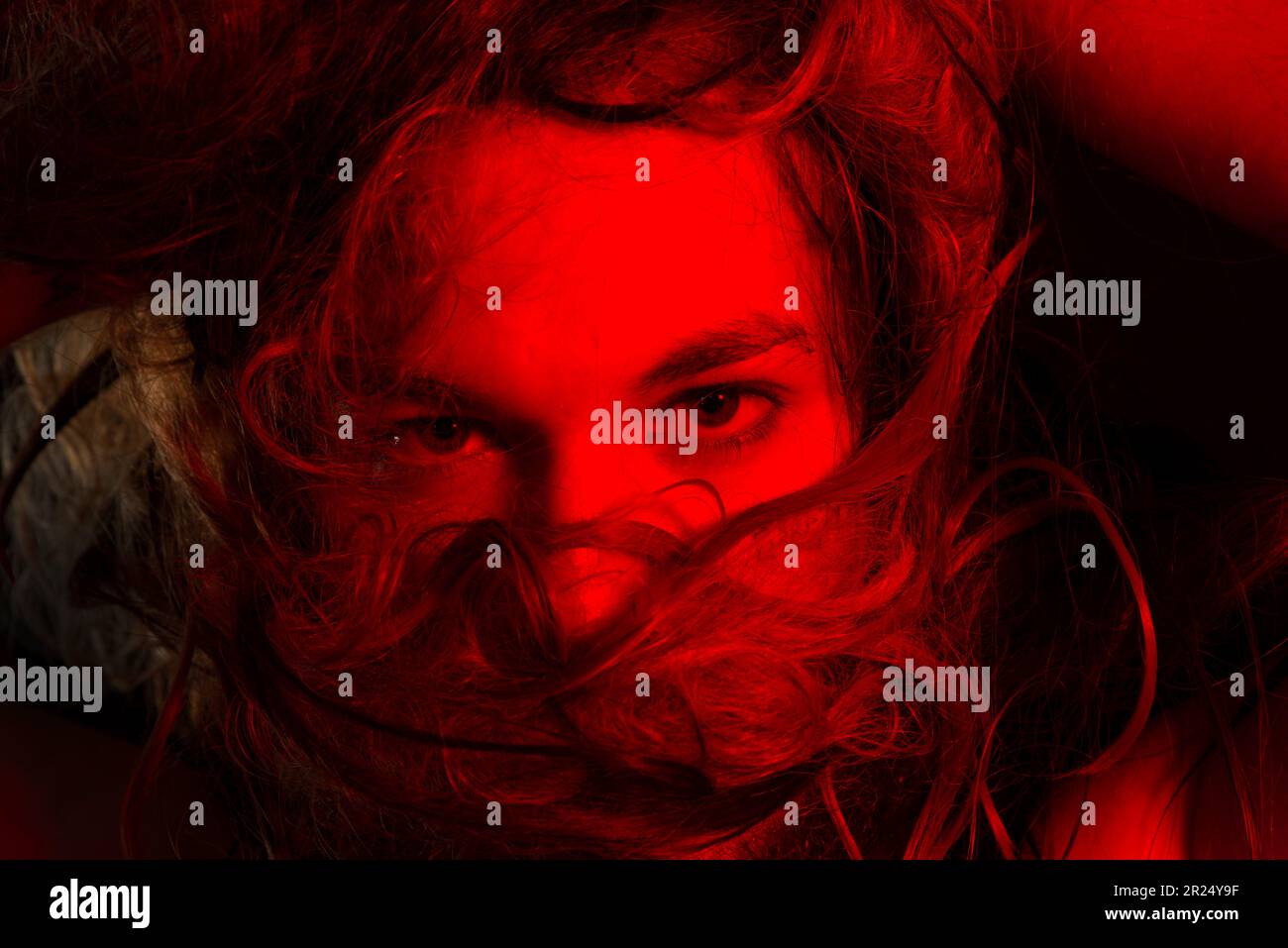 Close-up portrait of handsome young man with hair all over his face ...