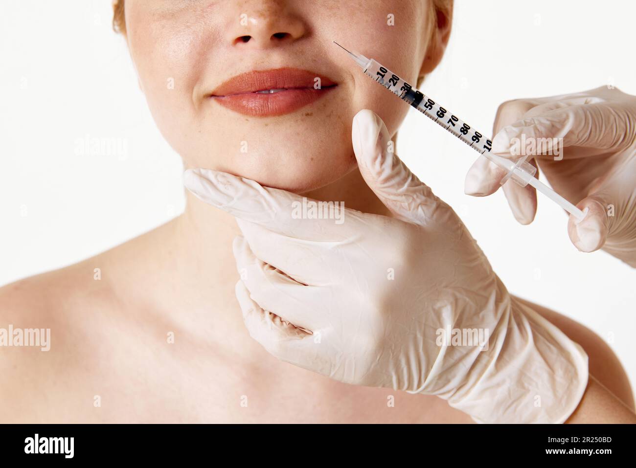 Anti-wrinkles care. Cropped image of female face with syringe making ...