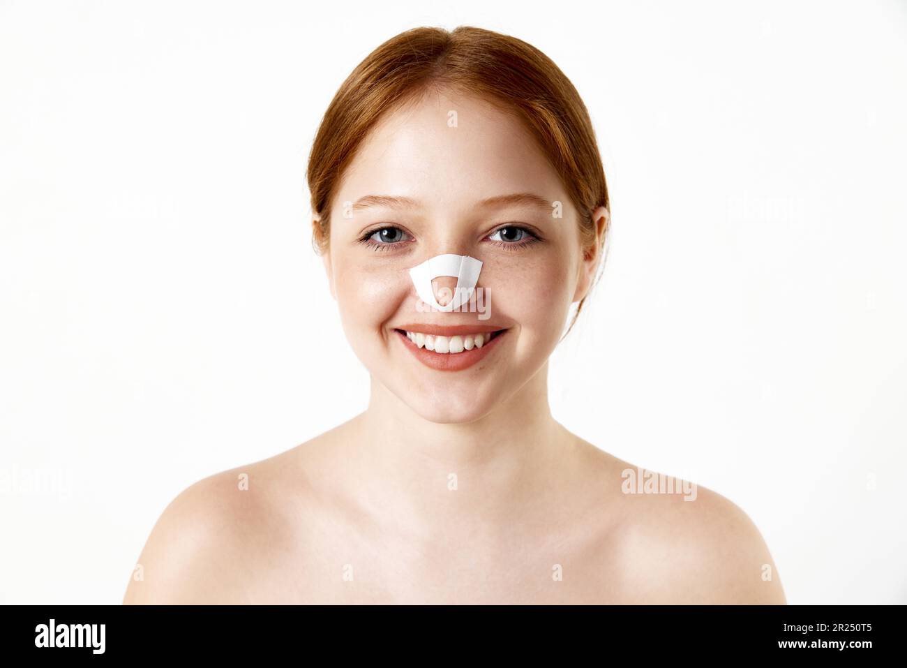 Portrait of young beautiful girl with bandage on her nose after ...