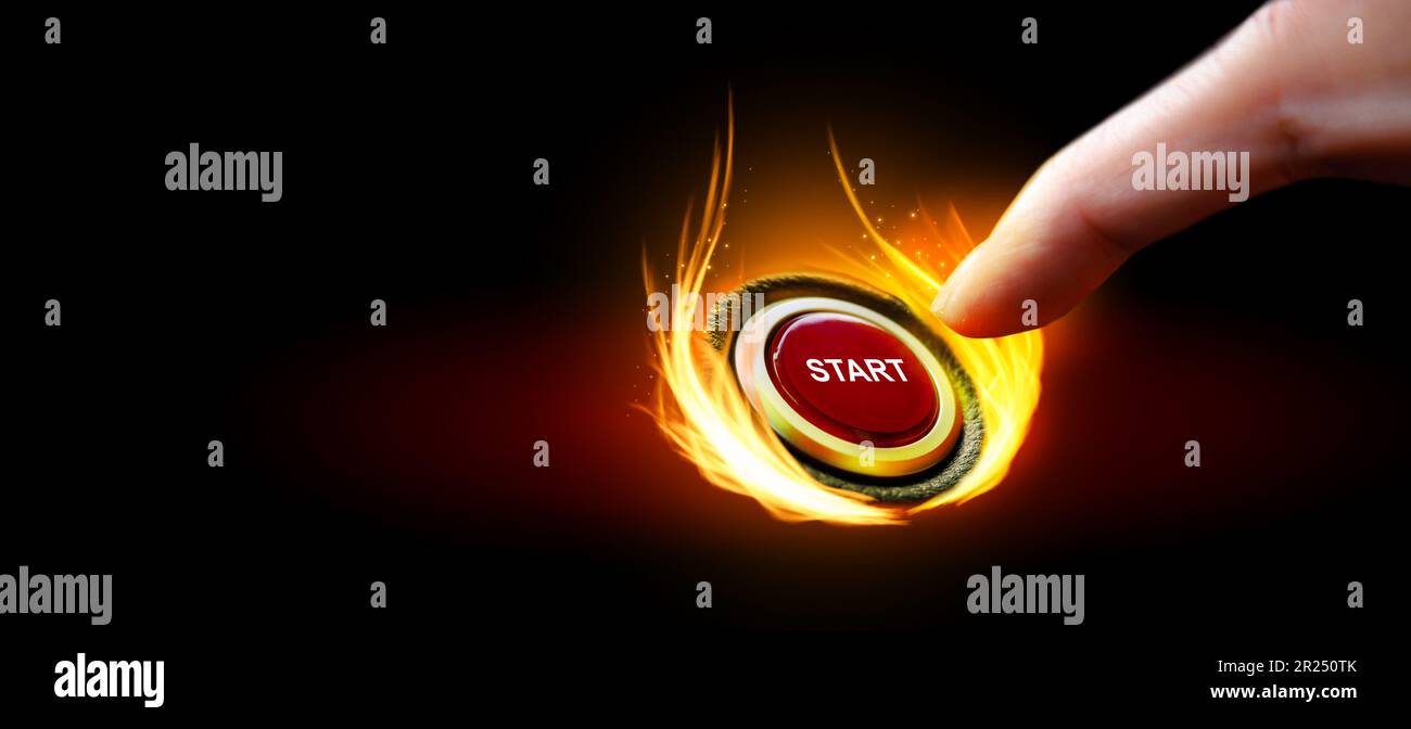Human hand pressing on red start button with fiery flames on dark ...